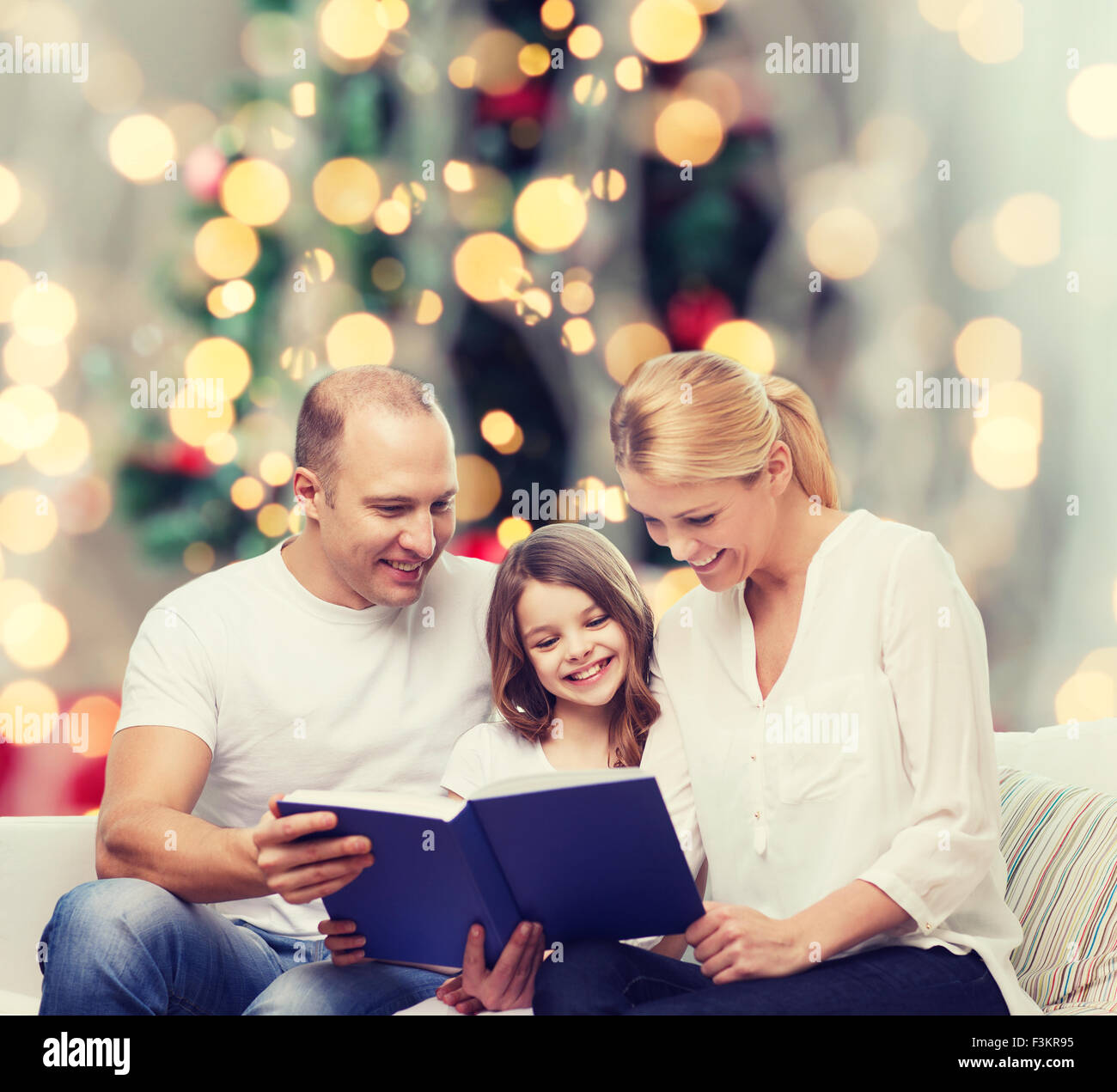 happy family with book at home Stock Photo - Alamy