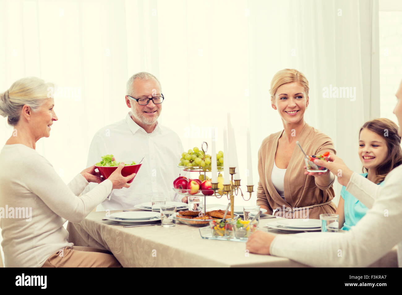 smiling family having holiday dinner at home Stock Photo - Alamy