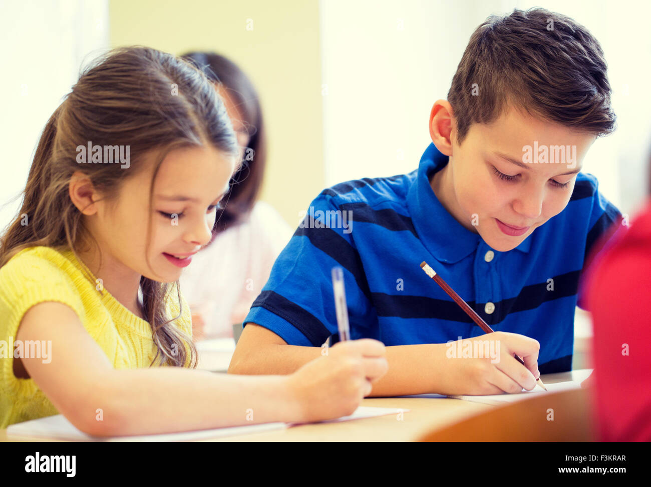 group of school kids writing test in classroom Stock Photo - Alamy