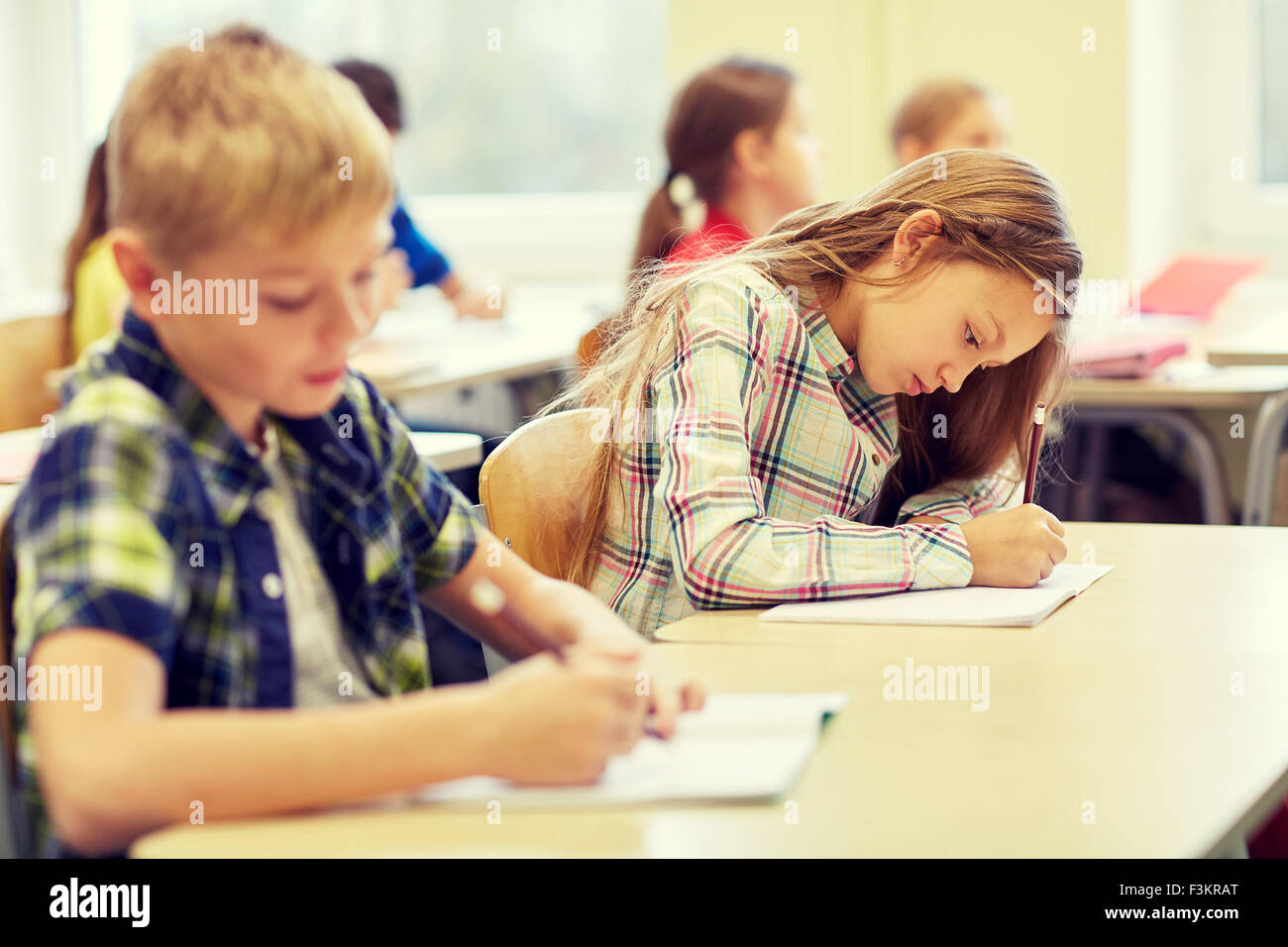 group of school kids writing test in classroom Stock Photo - Alamy