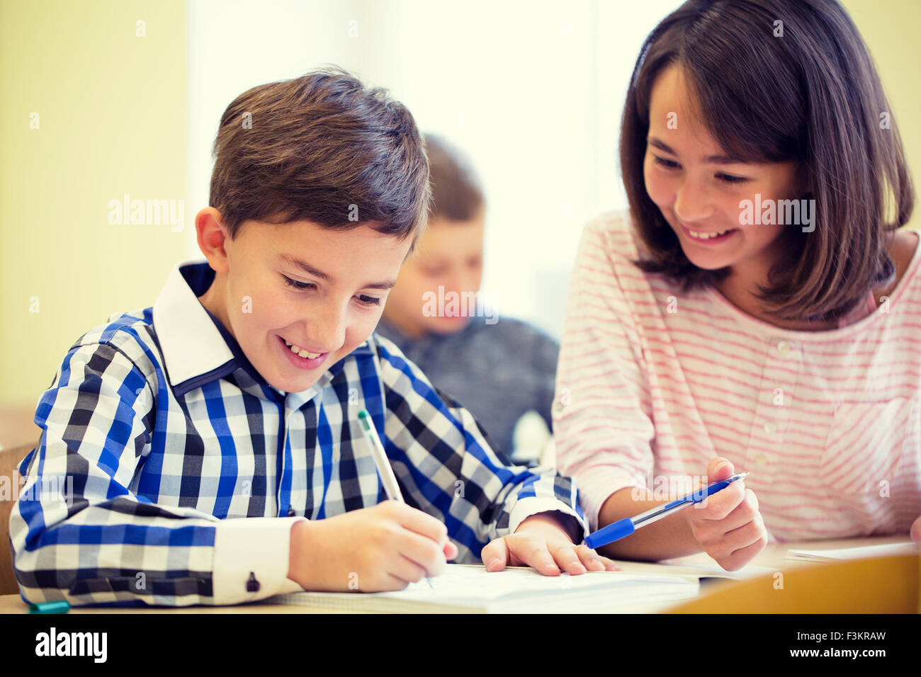 group of school kids writing test in classroom Stock Photo - Alamy