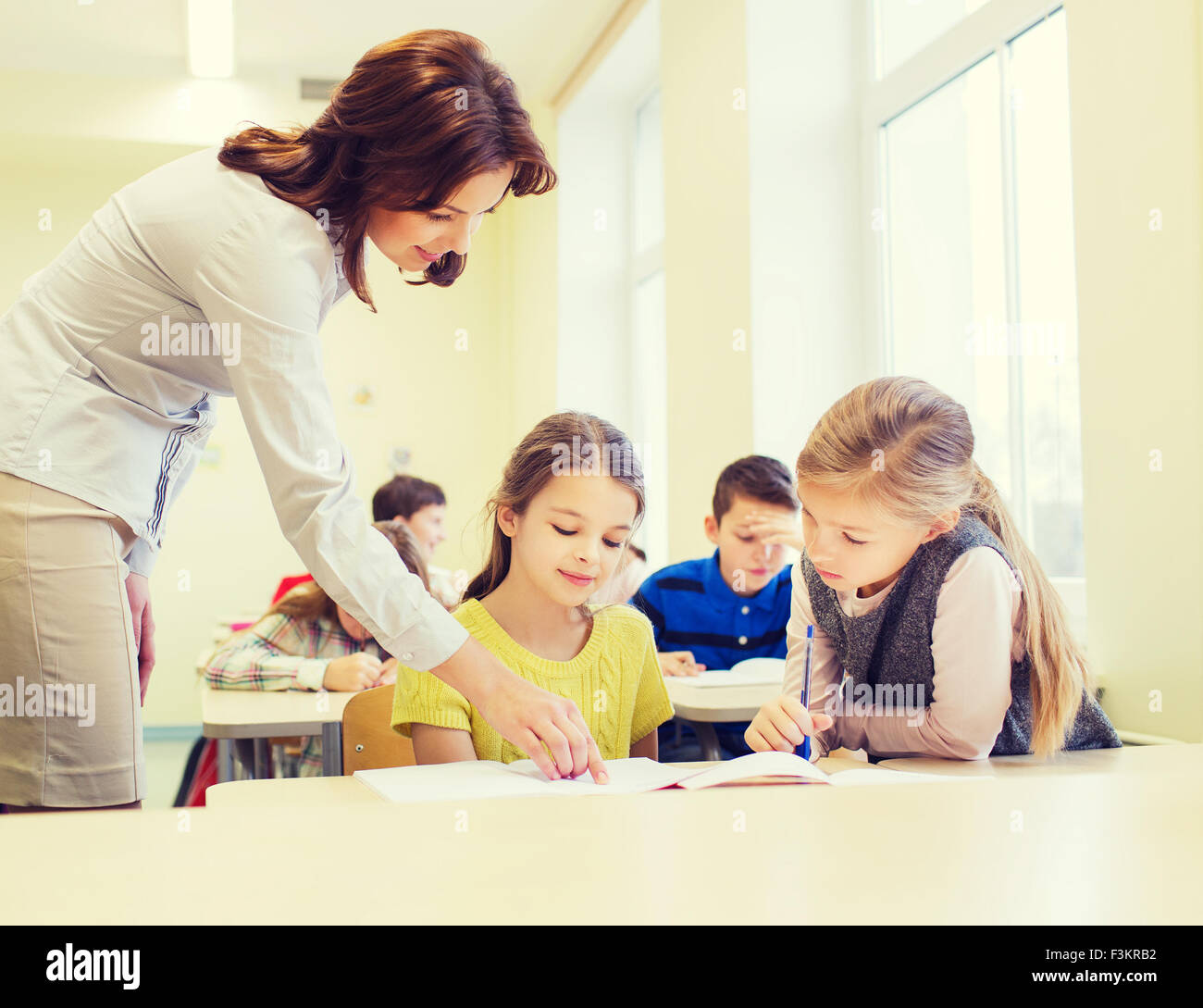 group of school kids writing test in classroom Stock Photo - Alamy