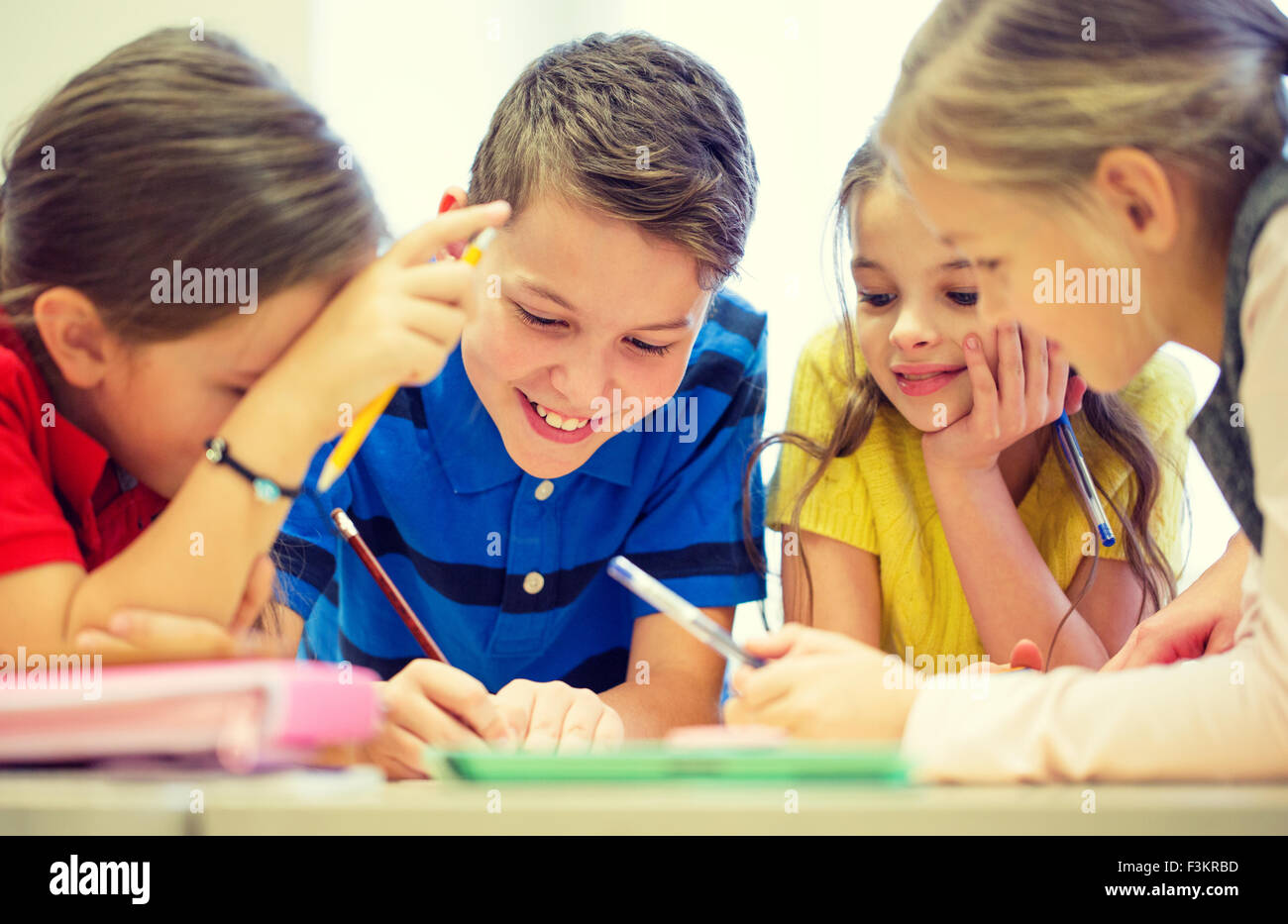 group of students talking and writing at school Stock Photo - Alamy