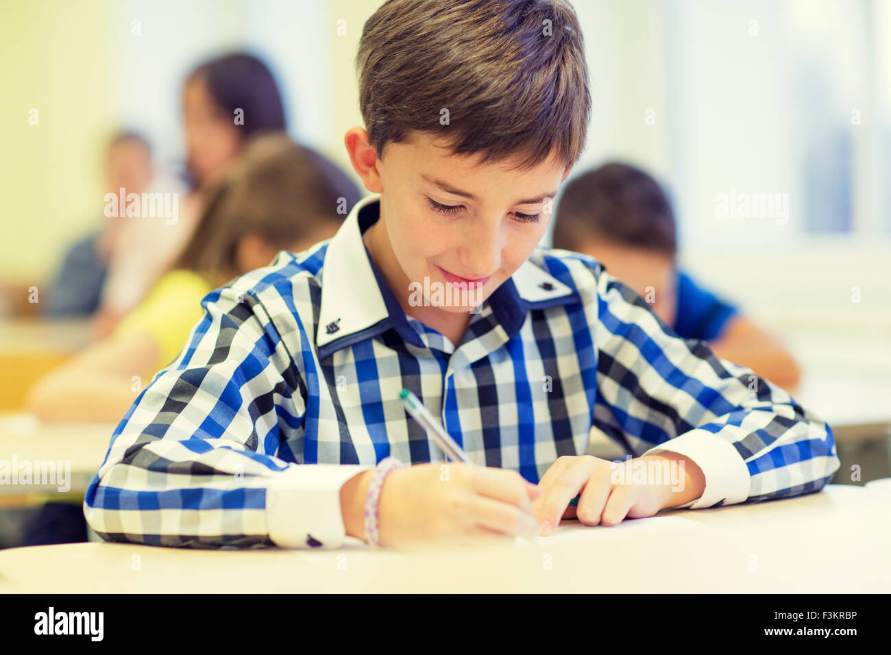 group of school kids writing test in classroom Stock Photo - Alamy