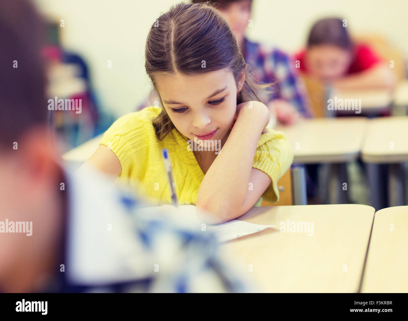 group of school kids writing test in classroom Stock Photo - Alamy
