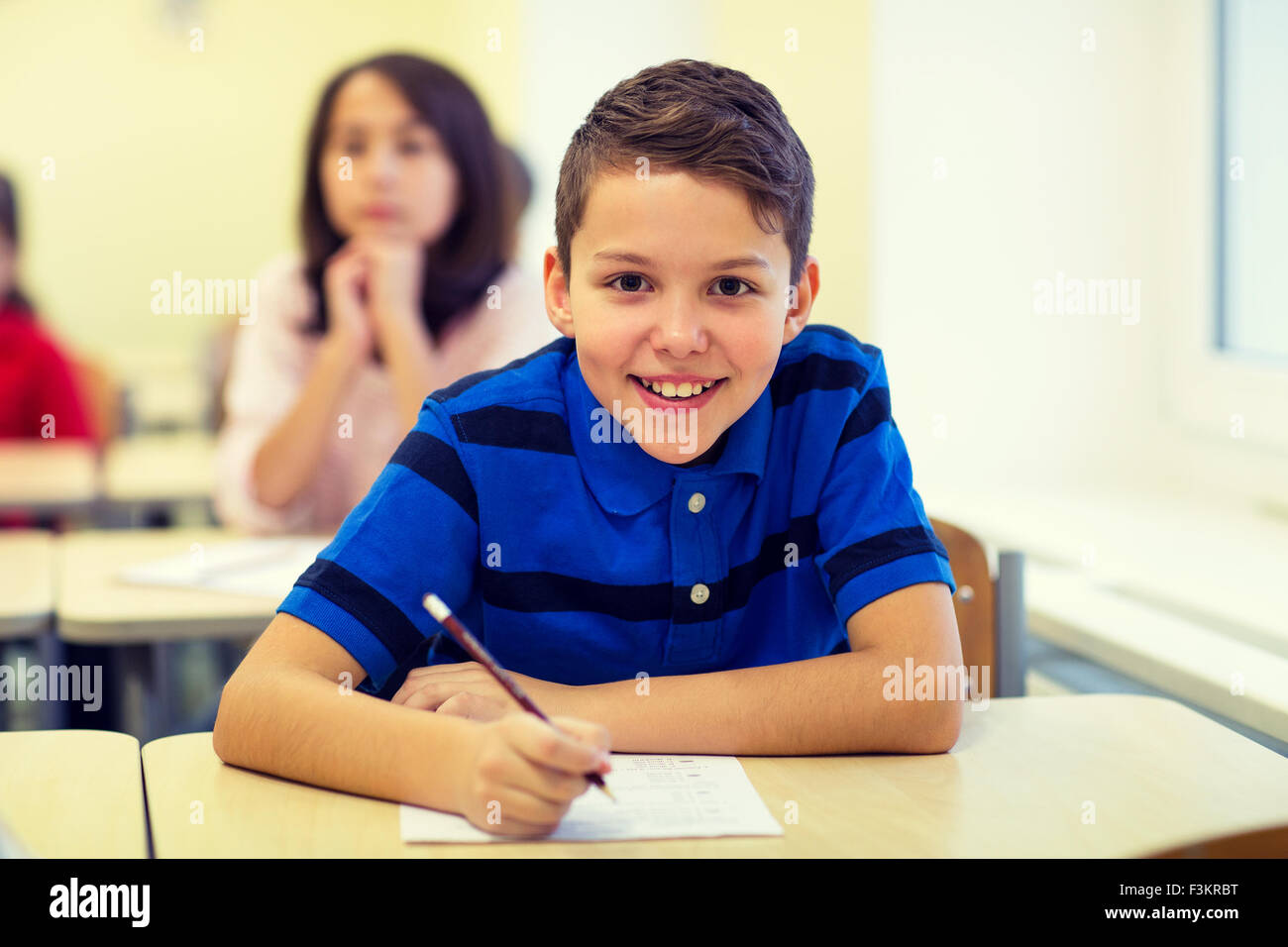group of school kids writing test in classroom Stock Photo - Alamy