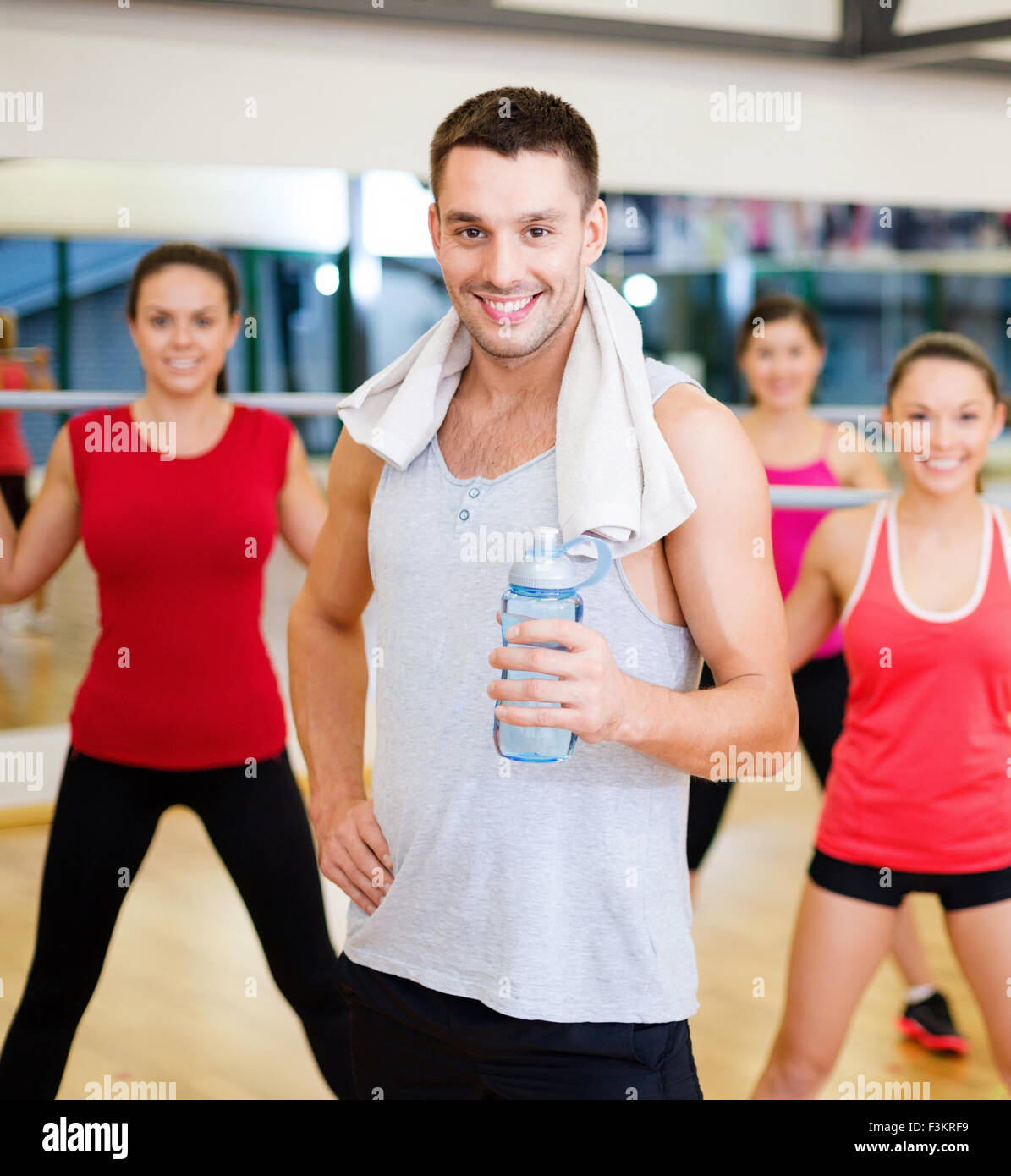 smiling trainer in front of group of people Stock Photo - Alamy