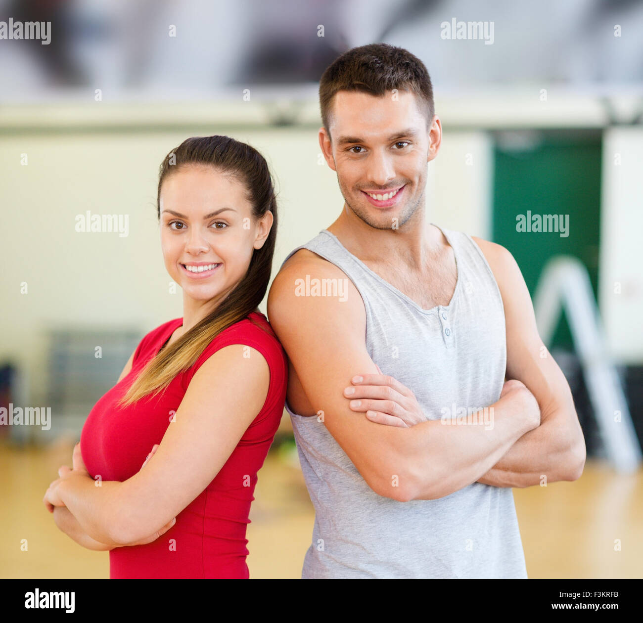 two smiling people in the gym Stock Photo - Alamy