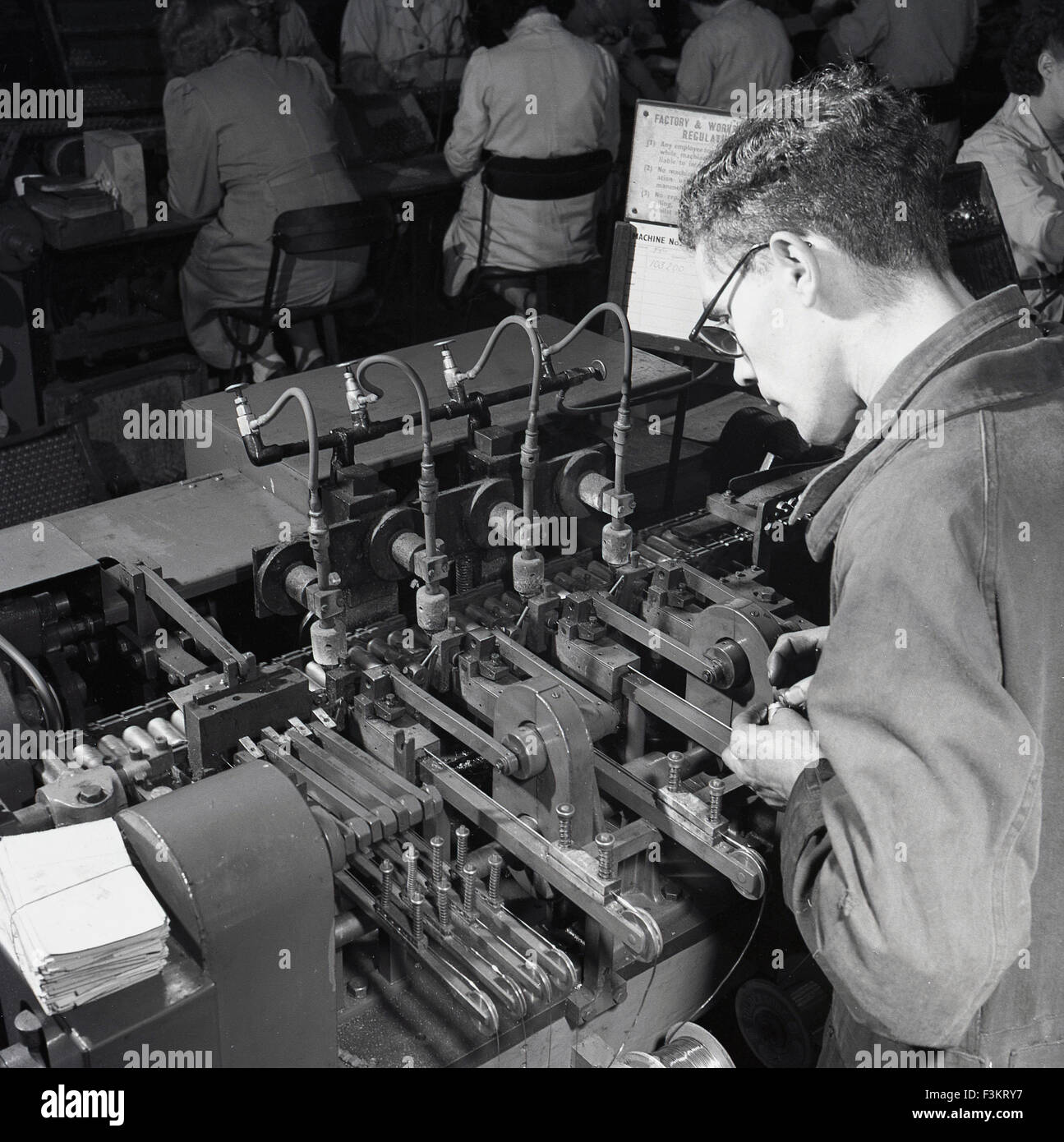 Historical, 1950s, male engineer checking a machine at the British Ever ...