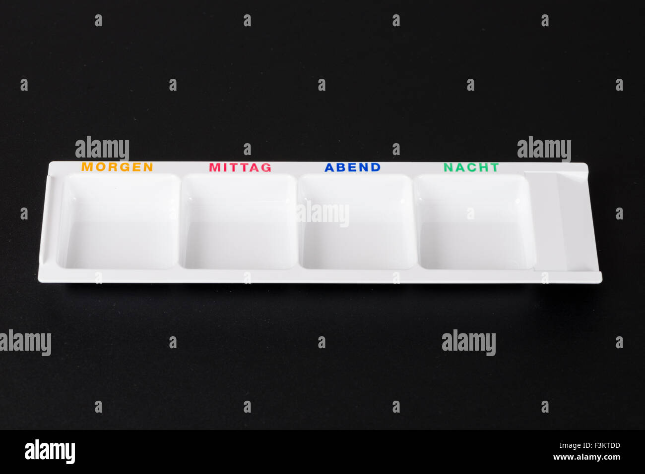 An empty white medicine box for the daily organizing of medication ...