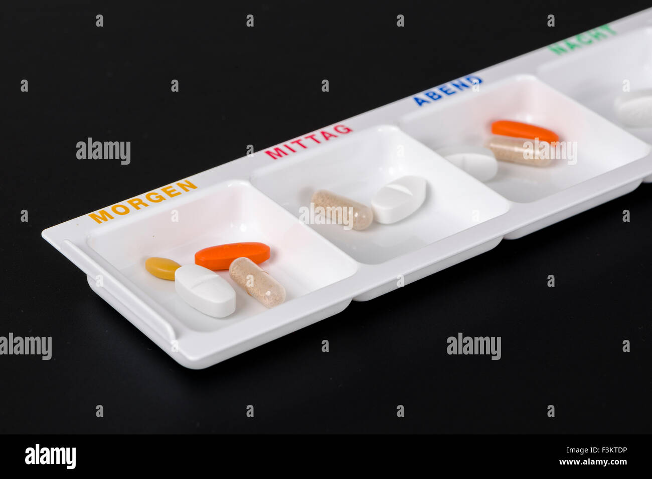 A white medicine box for the daily organizing of medication, filled ...