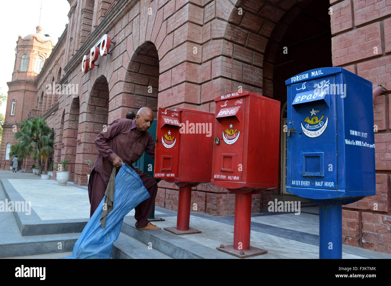 Lahore. 9th Oct, 2015. A Pakistani postman collects mails at a post ...
