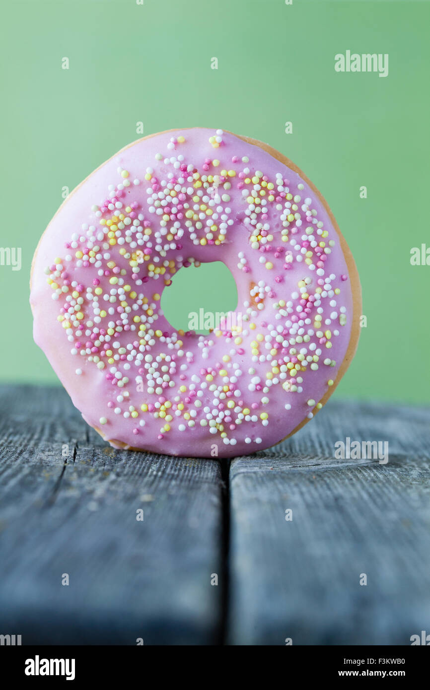 donut with pink frosting and sprinkles Stock Photo - Alamy