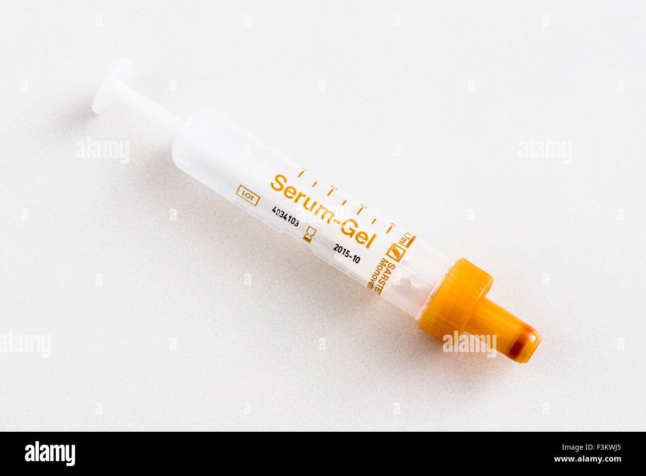 An orange pharmaceutical phial for medical use, displayed on a white ...