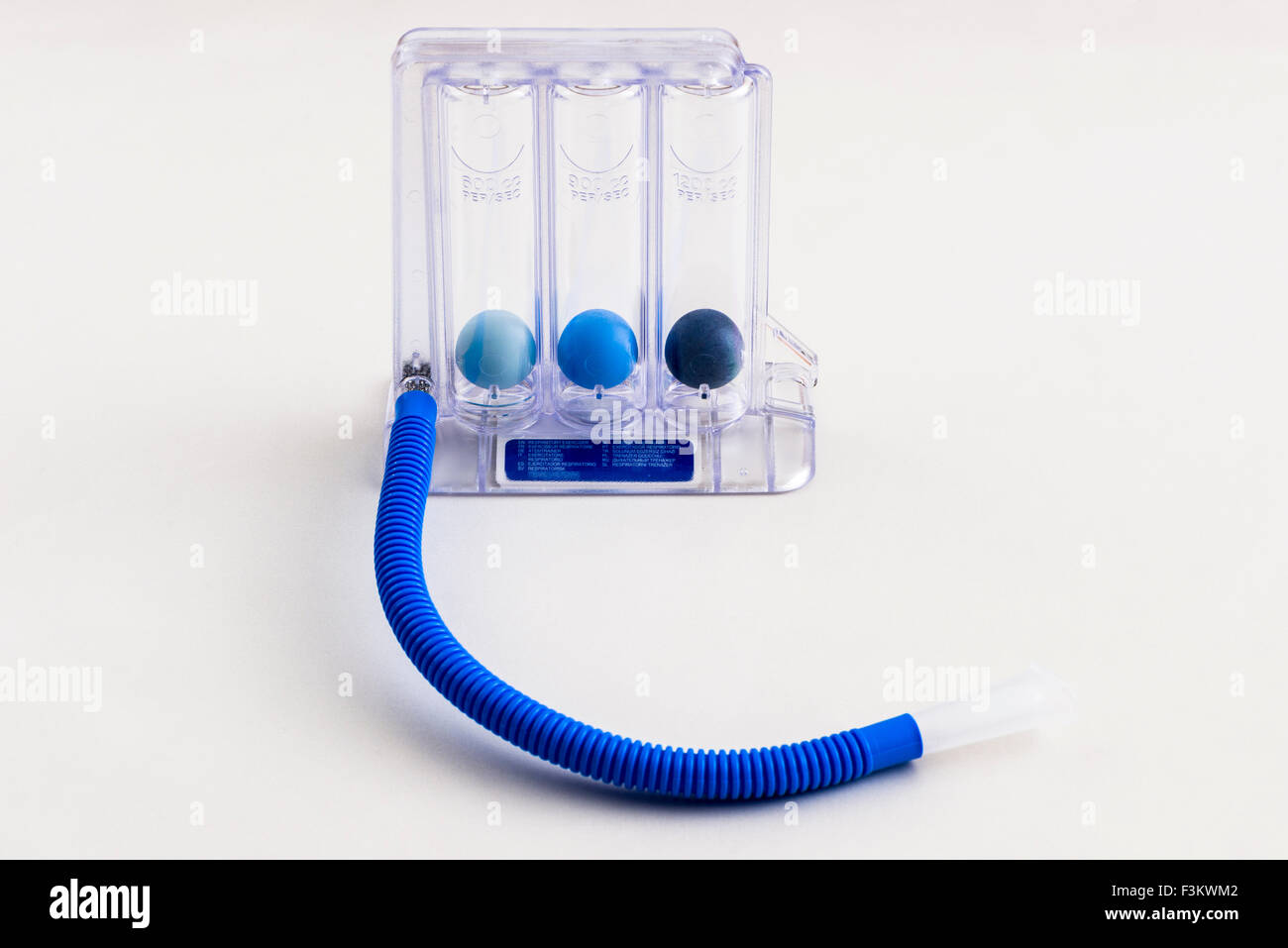 A respiratory exerciser for medical use, displayed on a white table ...