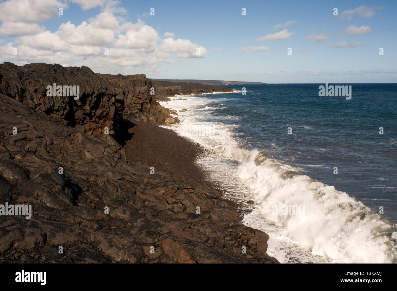 Black lava mountains near the coast and highway Chain of Crater Road ...
