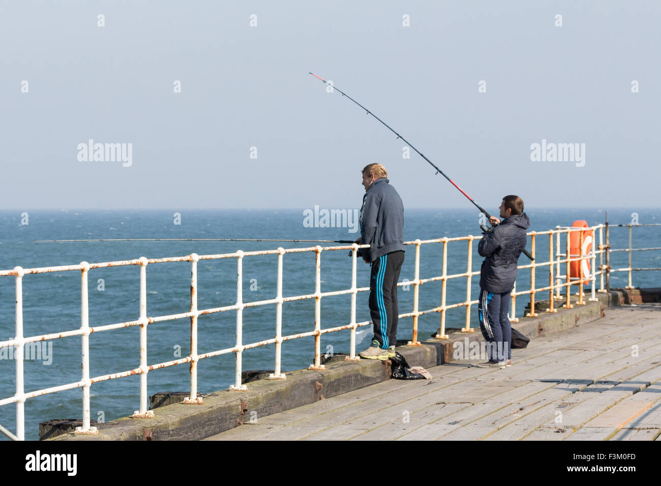 fishing off west pier at Whitby, North Yorkshire, England Stock Photo ...