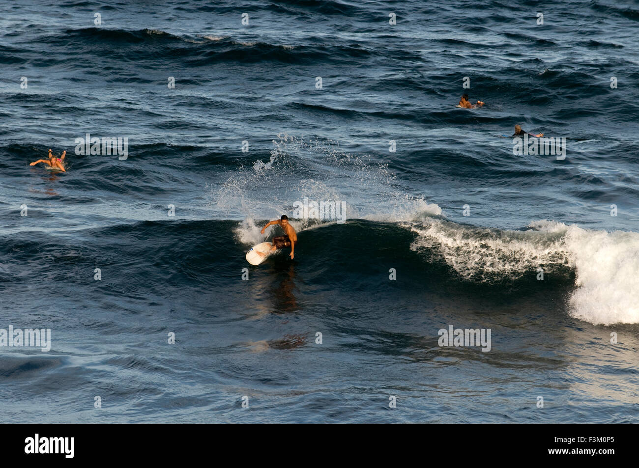 Surfers. Honoli'i beach where most practitioners to surf are women ...