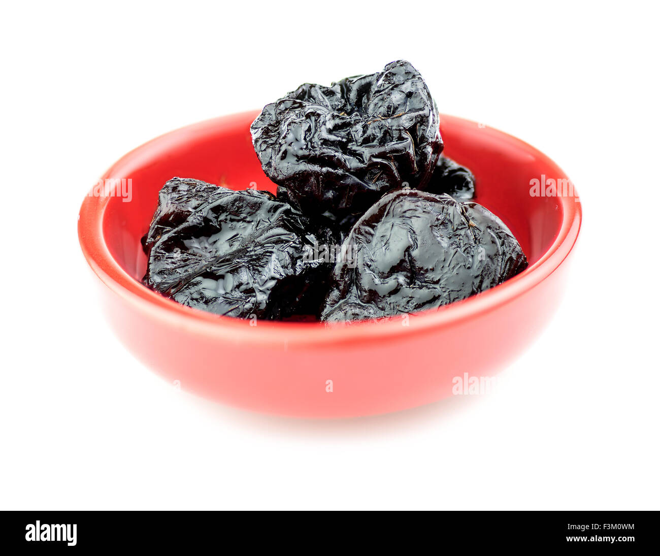 Prunes pitted and dehydrated isolated on white background in bowl Stock ...