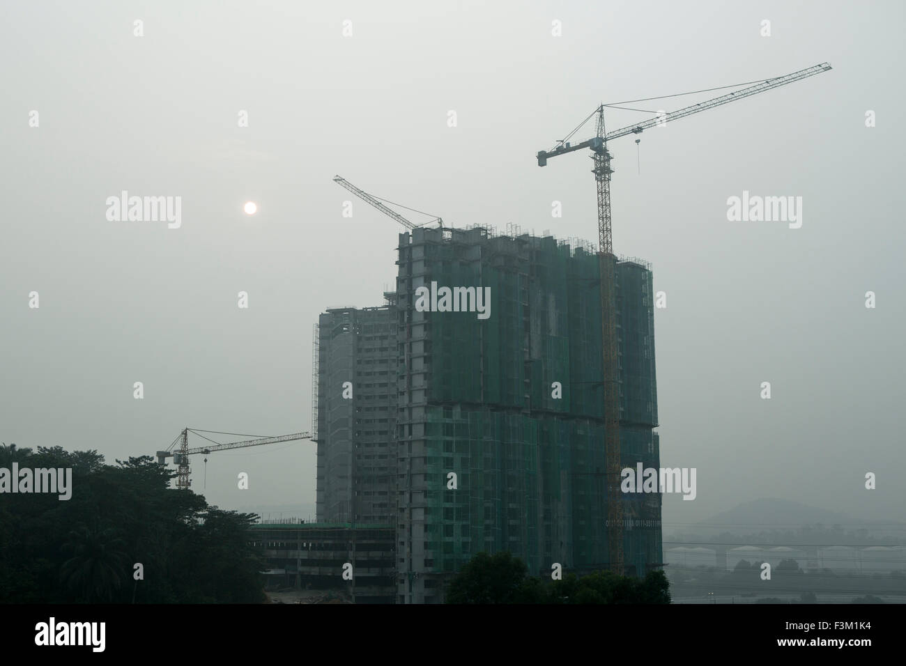 The sun is seen through heavy haze over a housing project under ...