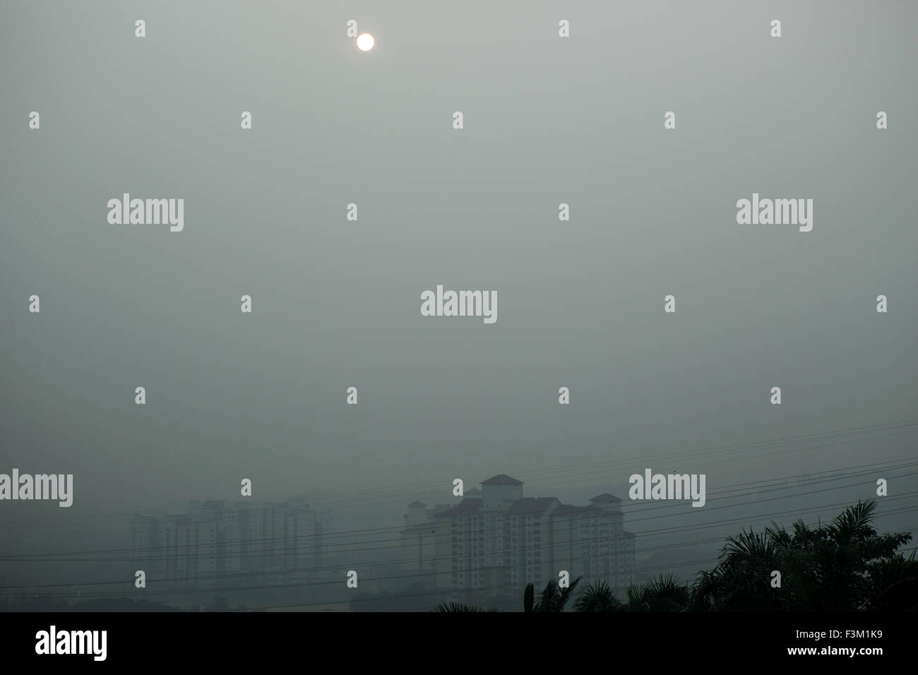 The sun is seen through heavy haze over a housing project outside Kuala ...