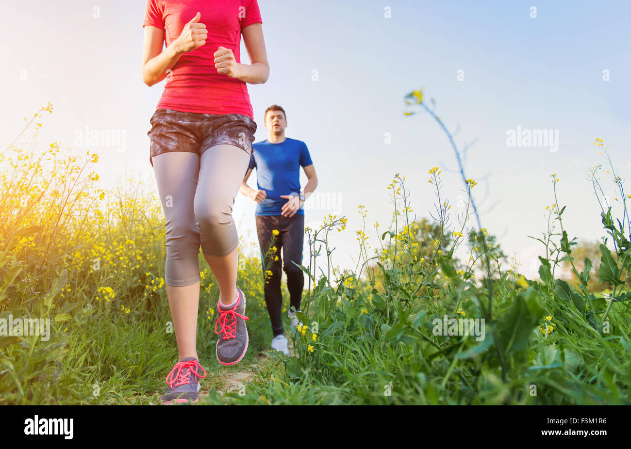 Young couple running Stock Photo - Alamy