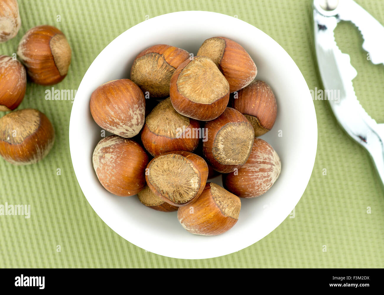 Natural hazelnuts in bowl with nut cracker aerial Stock Photo - Alamy