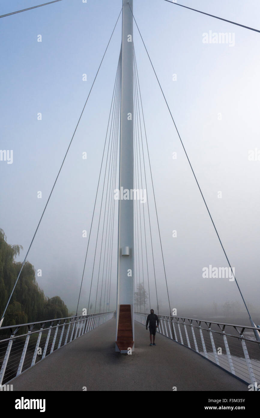 Pedestrian on foot and cycle bridge over River Thames, Christchurch ...