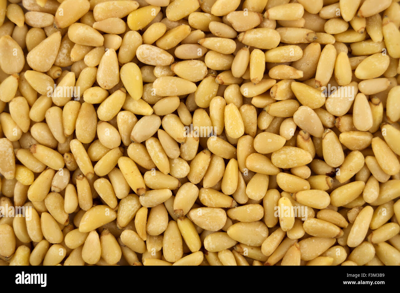 Closeup background texture of organic shelled pine nuts Stock Photo - Alamy