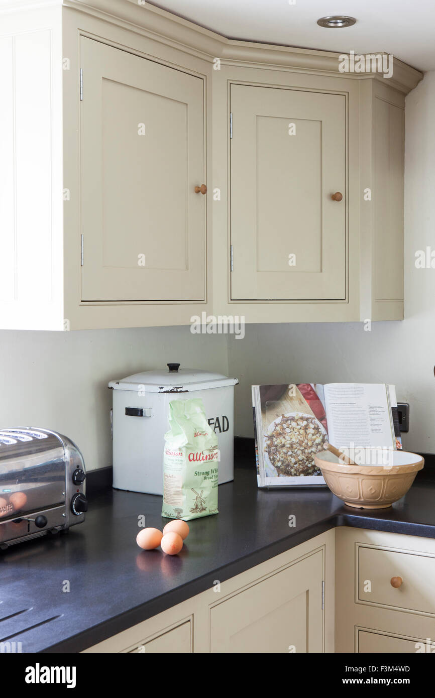 Corner of modern wooden kitchen with baking utensils and ingredients ...