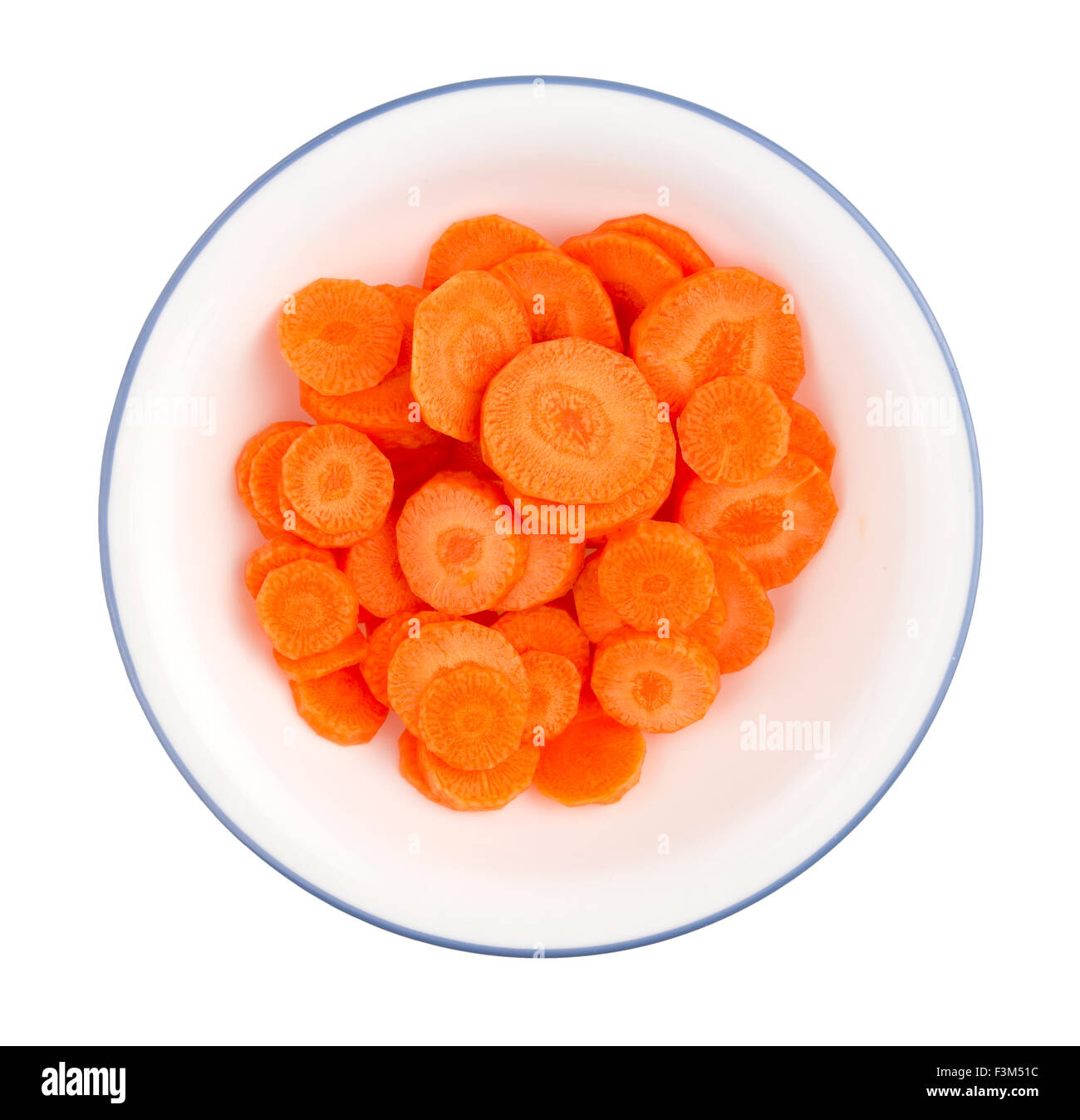Freshly cut round carrot pieces in a bowl isolated on white Stock Photo ...