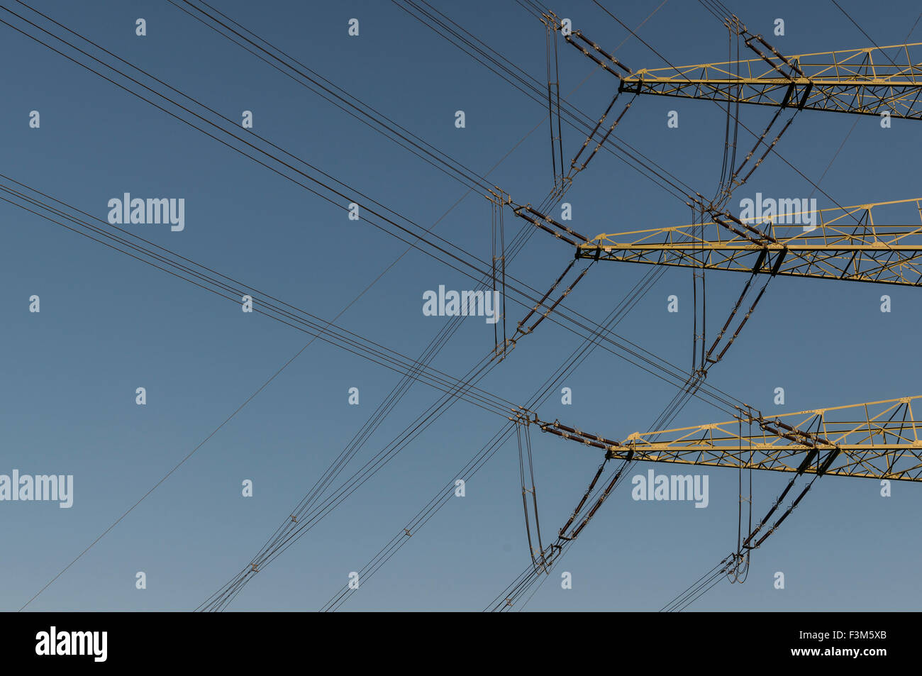Overhead powerline in front of blue sky Stock Photo - Alamy