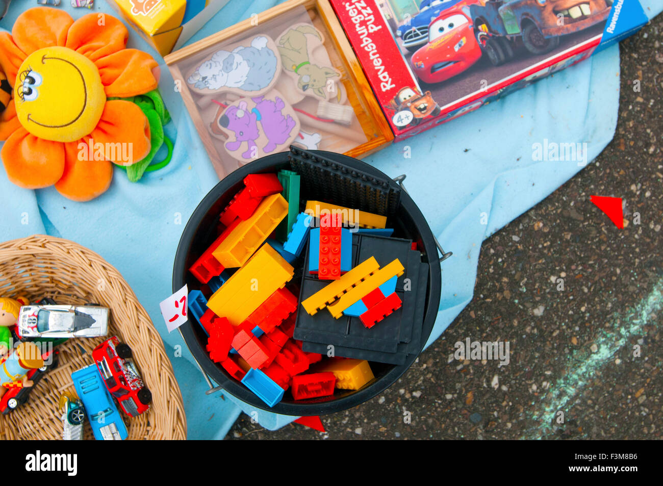 Assorted Items in close up flea market items spread on blanket/pavement ...