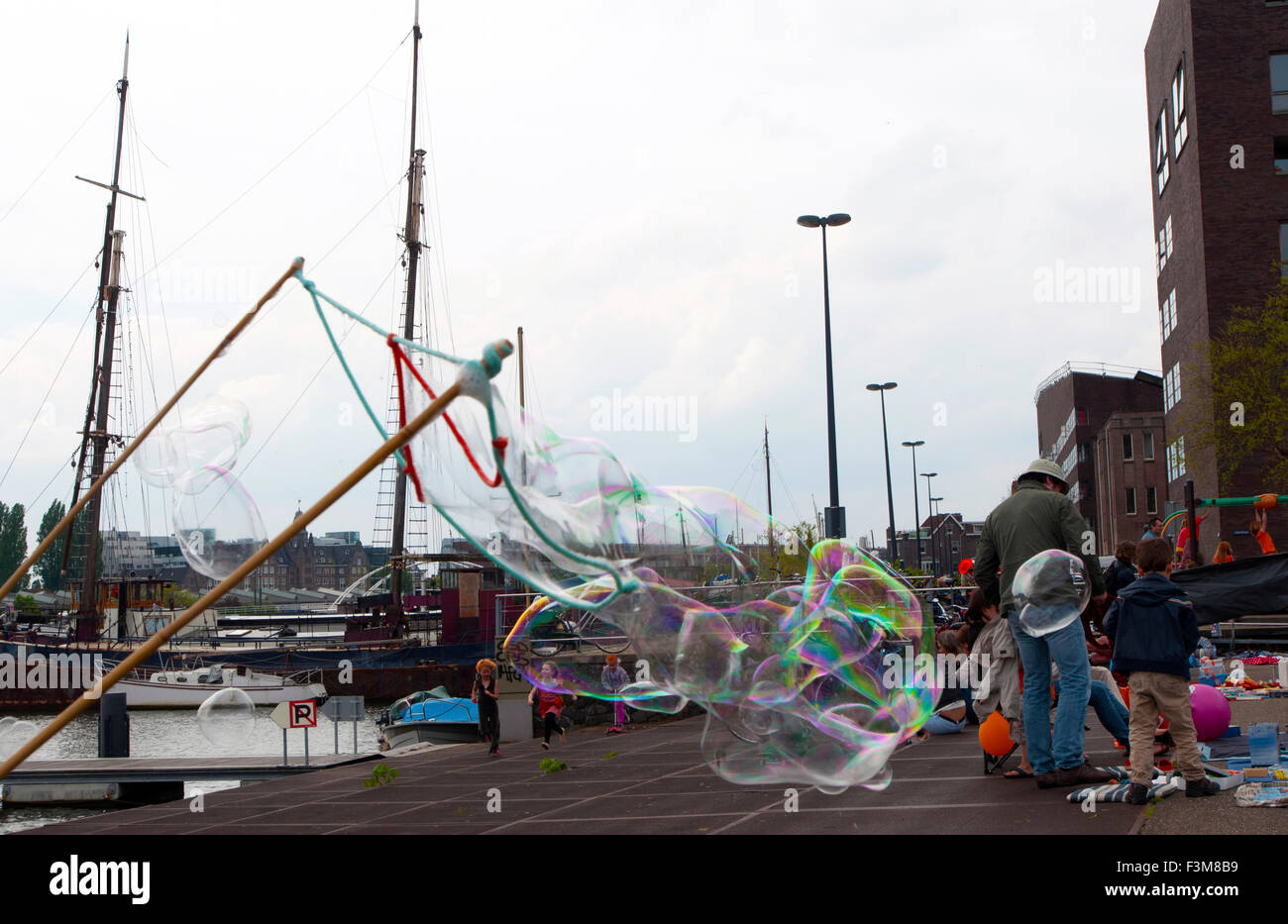 Large Soap bubbles and flea market at Kings Day, Amsterdam, The ...