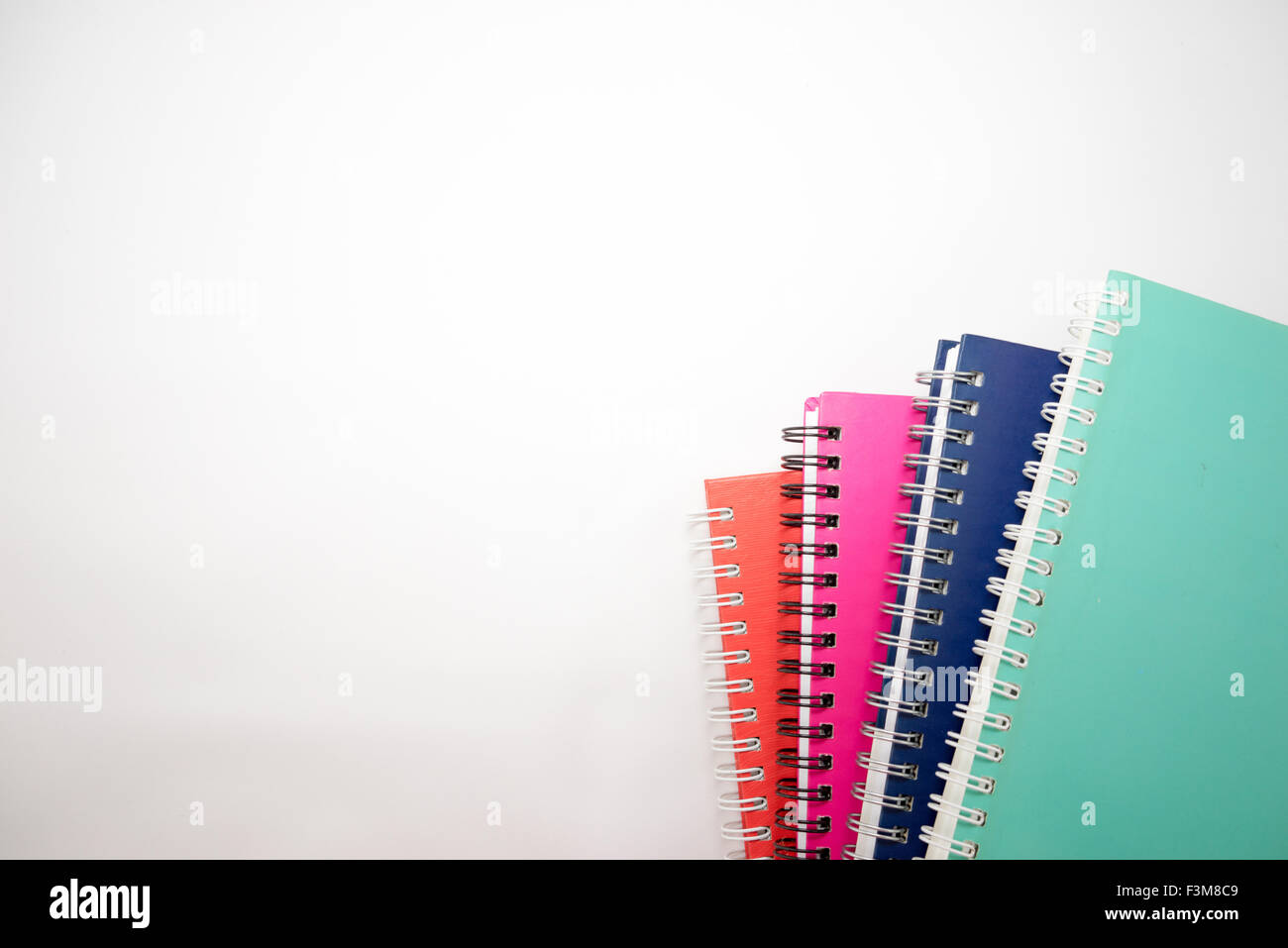 A few stacked notebooks isolated on white background Stock Photo - Alamy