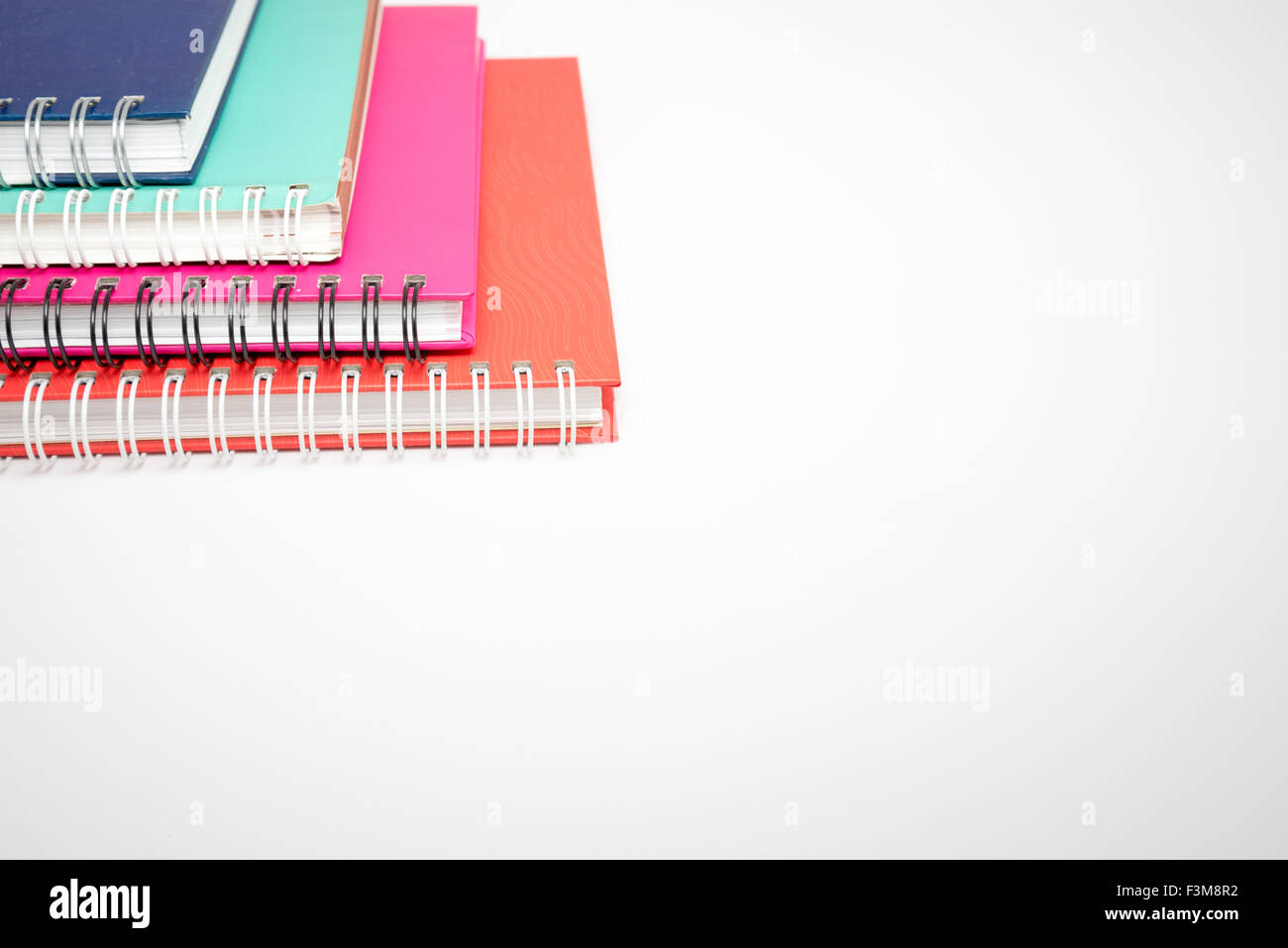 A few stacked notebooks isolated on white background Stock Photo - Alamy