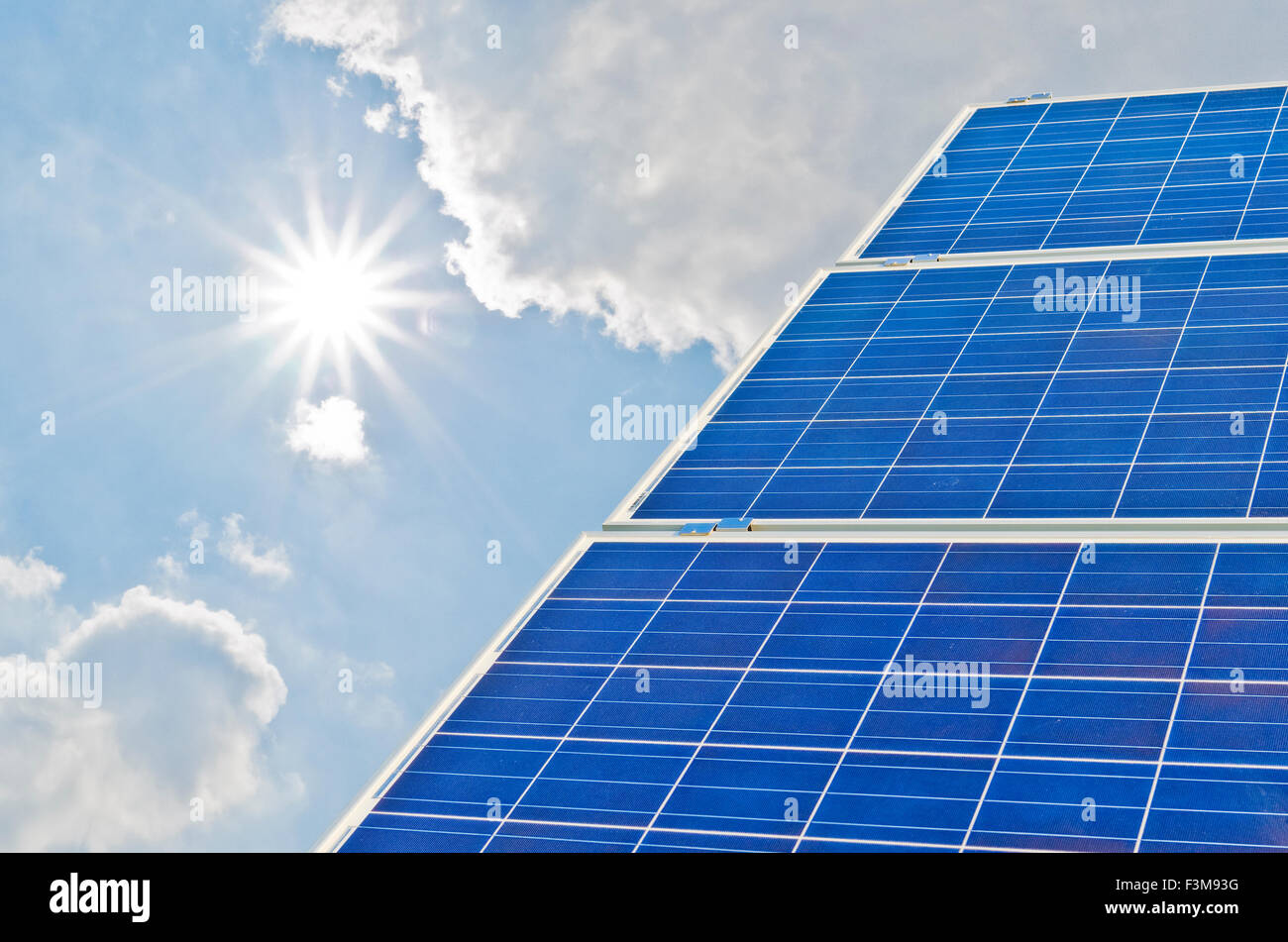 Photovoltaik solar panels against blue sky and bright sun Stock Photo ...