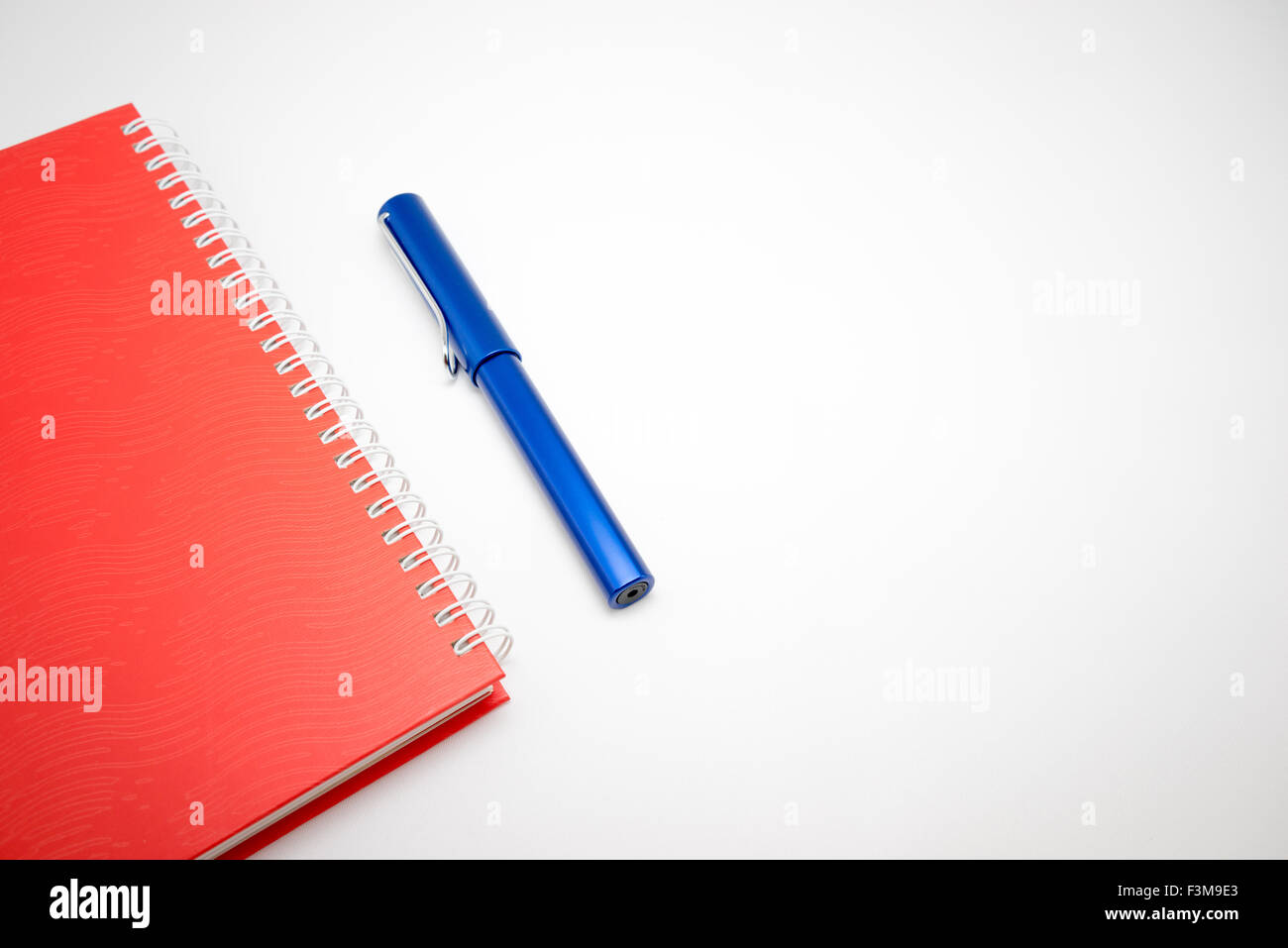 Notebook and pen isolated on white background Stock Photo - Alamy