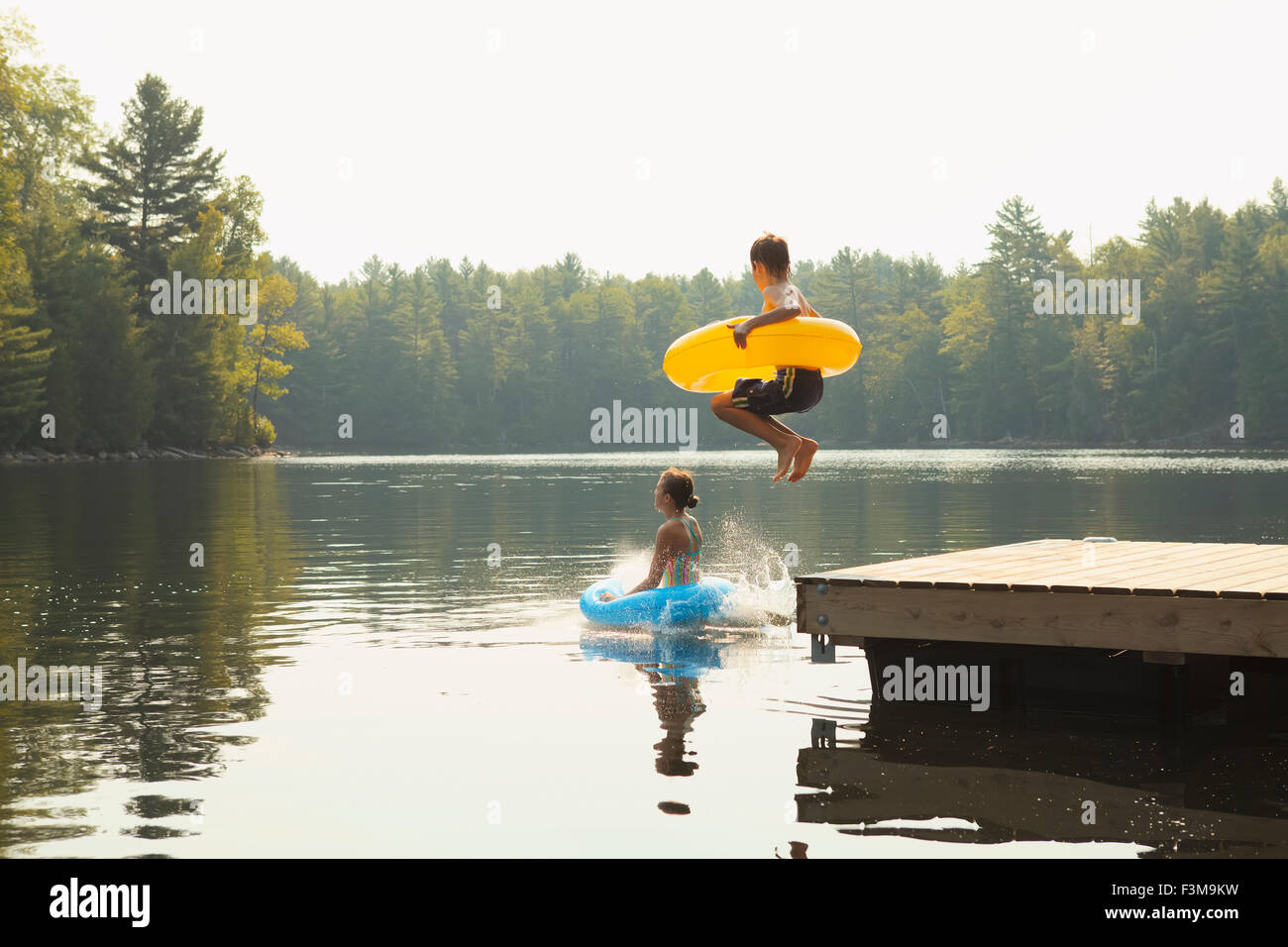 Two Girls Jumping Into The Lake High Resolution Stock Photography and ...