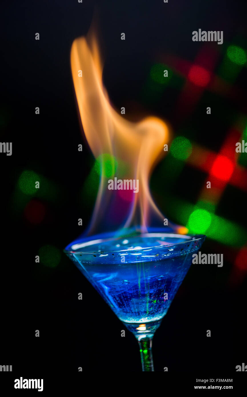 Fire blowing out of blue lagoon glass/close-up with black background ...