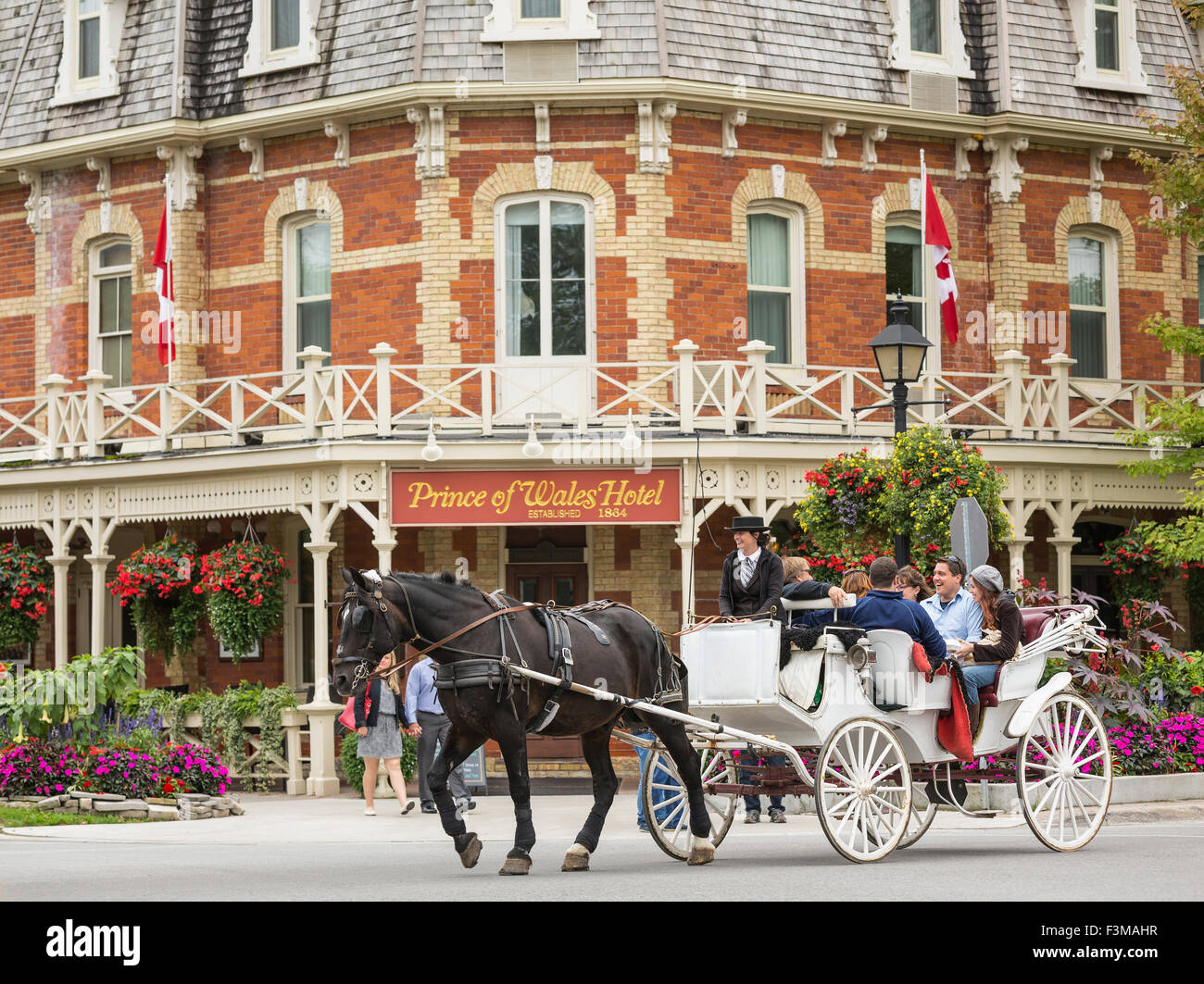 People riding on horse drawn carriage hi-res stock photography and ...