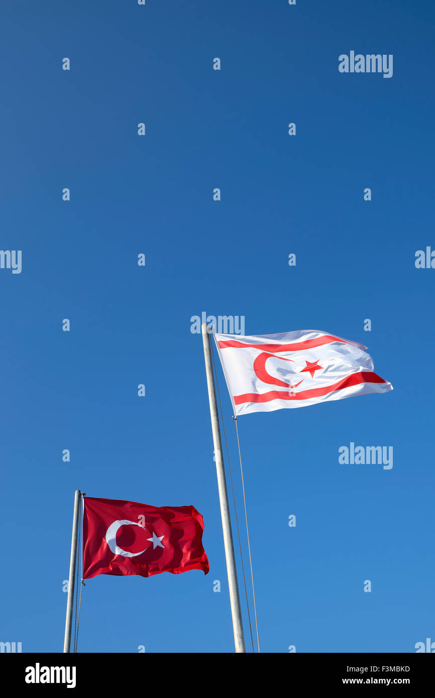 North Cypriot and Turkish flags flying side by side against a blue ...