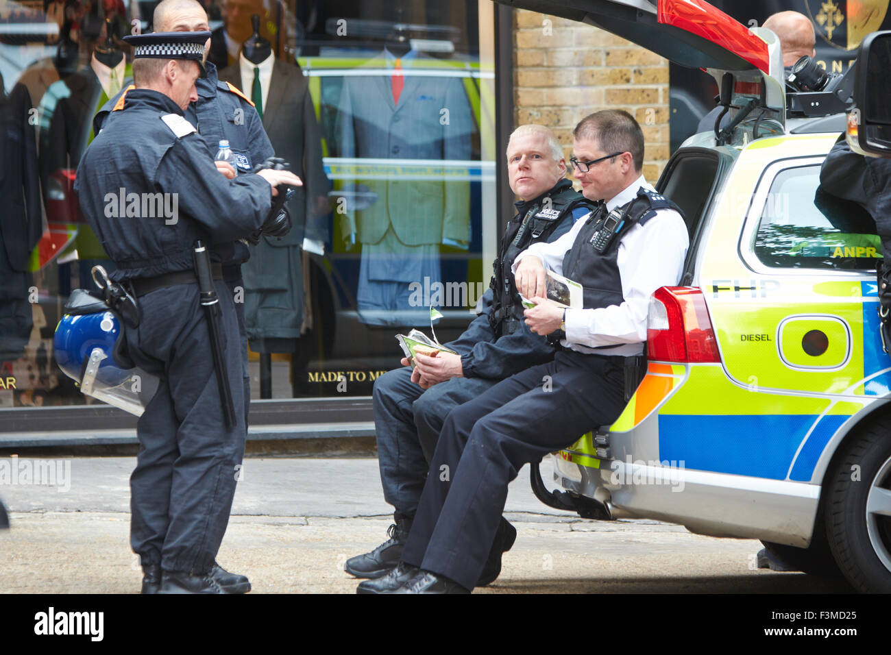 Police taking a break during the G8 protest in London Stock Photo - Alamy