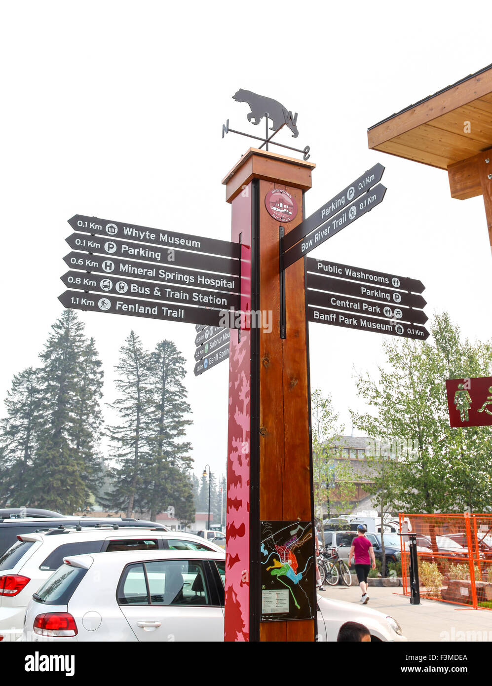 A sign post in downtown Banff with a bear weather vane on top Banff ...