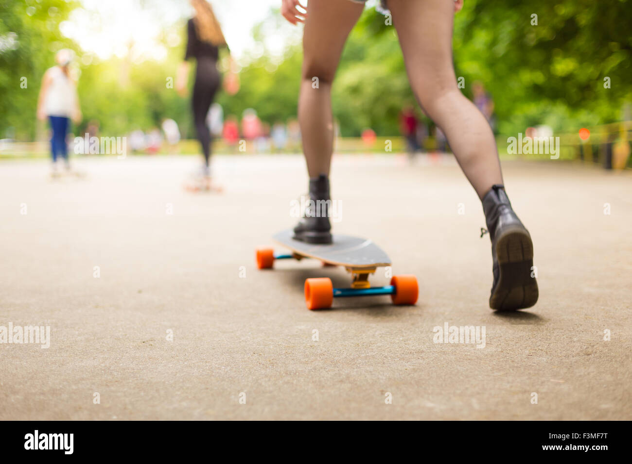 Teenage girl urban long board riding Stock Photo - Alamy