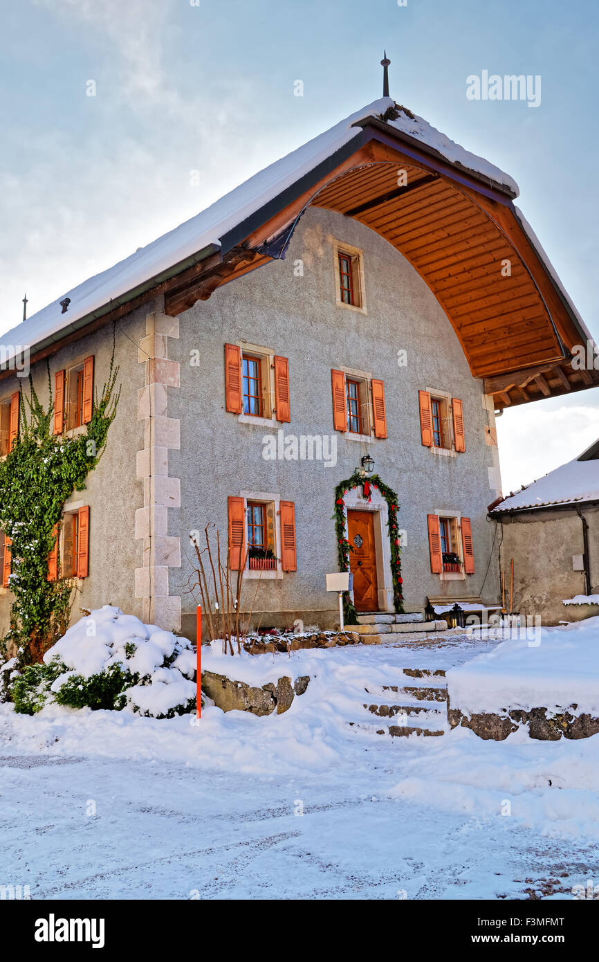Old stone building in the medieval town of Gruyere covered with green ...