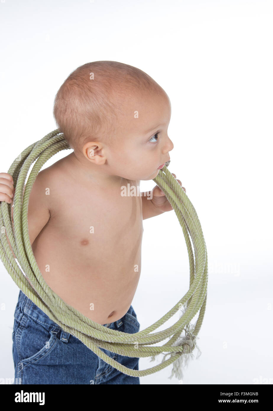 Baby boy playing and trying to figure out the lasso in studio Stock ...