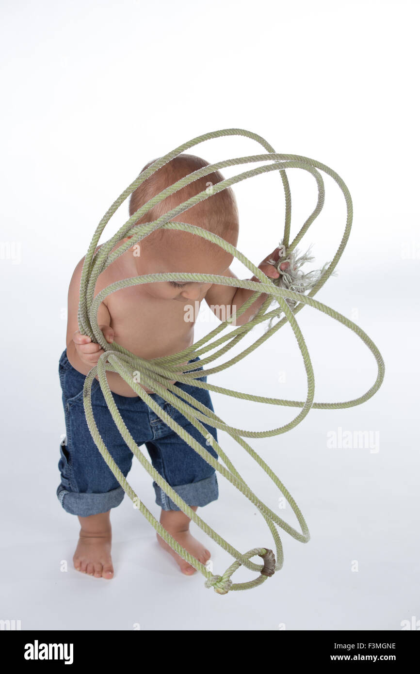 Baby boy trying to figure out lasso and showing confusion Stock Photo ...