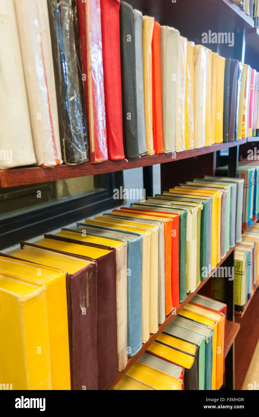 Old books in wooden bookcases in library Stock Photo - Alamy