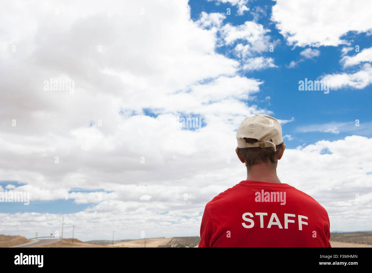 Staff label on a red t-shirt in the middle of nowhere with blue sky ...